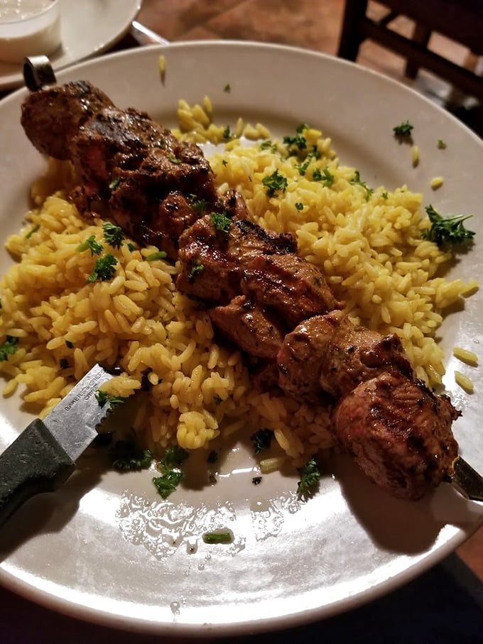 The legendary lamb kabob arrives like royalty on a bed of saffron rice. This isn't just meat on a stick—it's edible poetry.