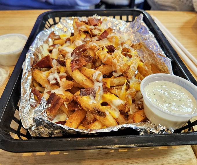 Behold the star of our show! These loaded fries aren't just a side dish—they're a religious experience of cheese, bacon, and ranch that demands your full attention.