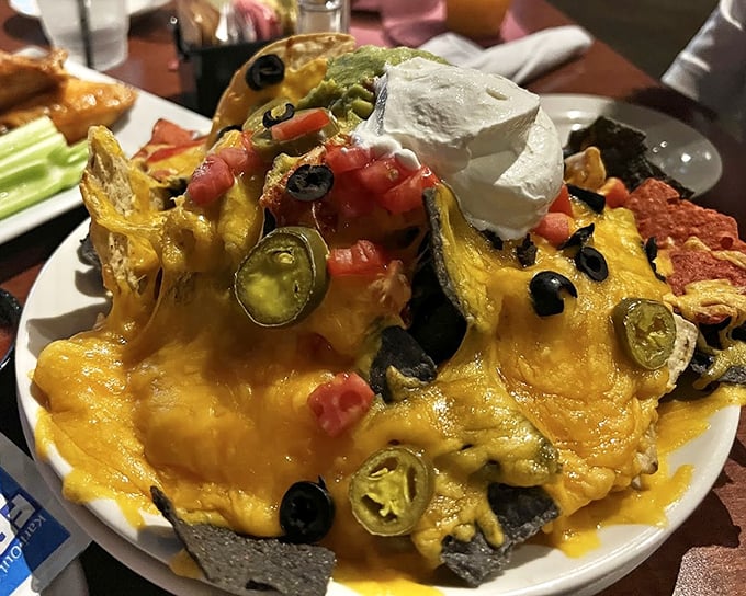 Behold the nacho mothership! This gravity-defying mountain of cheese, jalapeños, and perfectly distributed toppings makes sharing feel like a crime.