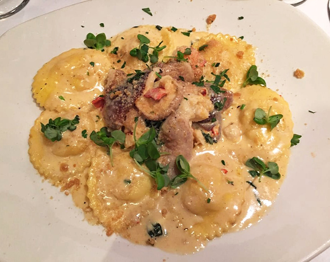 Lobster ravioli that could make an Italian grandmother weep with joy—pillows of pasta cradling sweet meat in a sauce worth bottling and taking home.