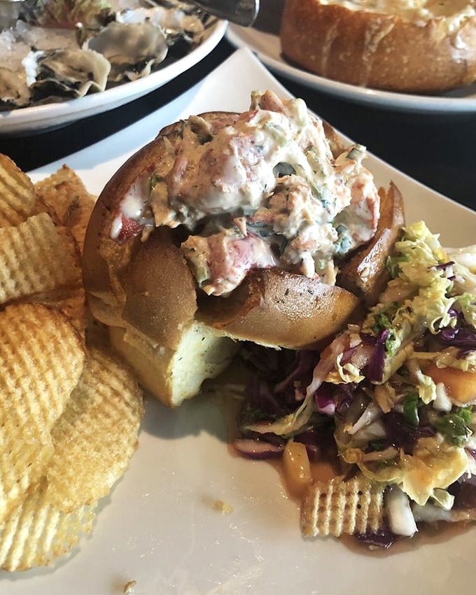 This isn't just a sandwich; it's a celebration of the sea — a lobster roll overflowing with tender lobster salad on toasted bread, served with house-made chips that crunch like autumn leaves.