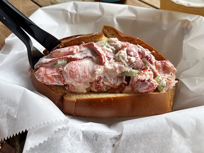 The legendary lobster roll in all its glory—chunks of Maine lobster barely held together by mayo and dreams.