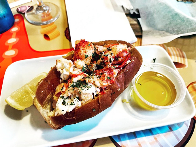 The lobster roll arrives like a celebrity on a red carpet—chunks of tender meat nestled in a perfectly toasted bun with a side of liquid gold butter.