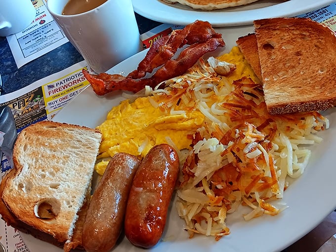 Breakfast perfection on a plate—crispy hash browns, golden toast, perfectly cooked eggs, and sausage links that snap with each bite. Morning glory, indeed!