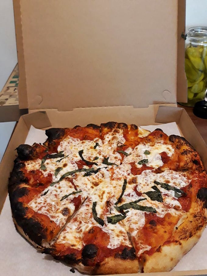 This isn't just pizza—it's a wood-fired masterpiece with those perfect leopard spots of char that pizza aficionados dream about. The basil looks like it was picked moments ago.