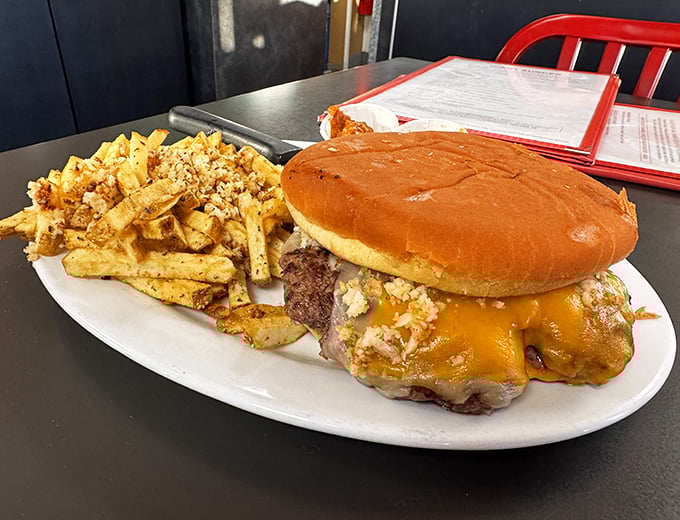 Behold the star attraction: a burger that requires both hands and a strategy. The cheese cascades like a molten waterfall.