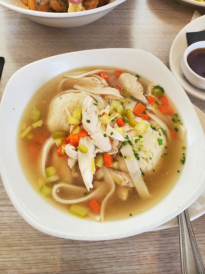 Matzo ball soup that would make your grandmother weep with joy—tender chicken, vibrant vegetables, and a matzo ball that's achieved perfect buoyancy.