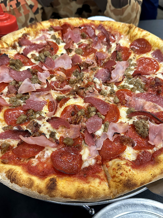 This meat lover's pizza doesn't just have toppings—it has a carnivorous congregation celebrating on a perfectly crispy crust. Vegetarians, avert your eyes.