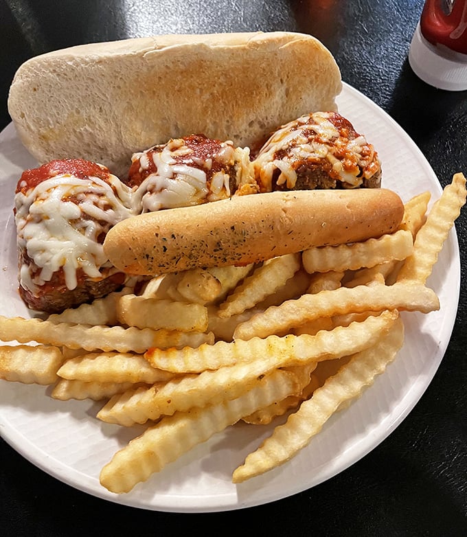 This meatball sub isn't just a sandwich—it's an engineering marvel. Three perfectly seasoned spheres of beef nestled in melted cheese, demanding both hands and several napkins.