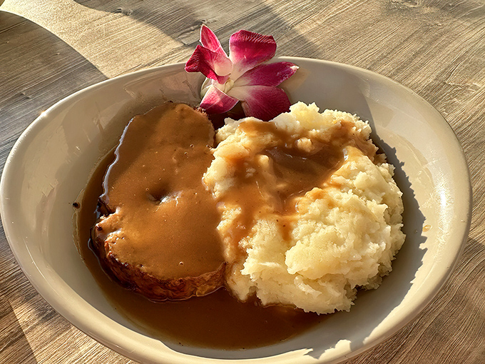 Behold the star attraction: Carol's Meatloaf with creamy mashed potatoes, swimming in gravy that would make your grandmother both jealous and proud.
