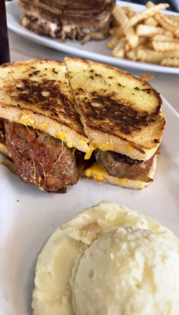 This isn't just a sandwich; it's a masterclass in comfort food architecture where melty cheese meets savory meatloaf between perfectly grilled bread.