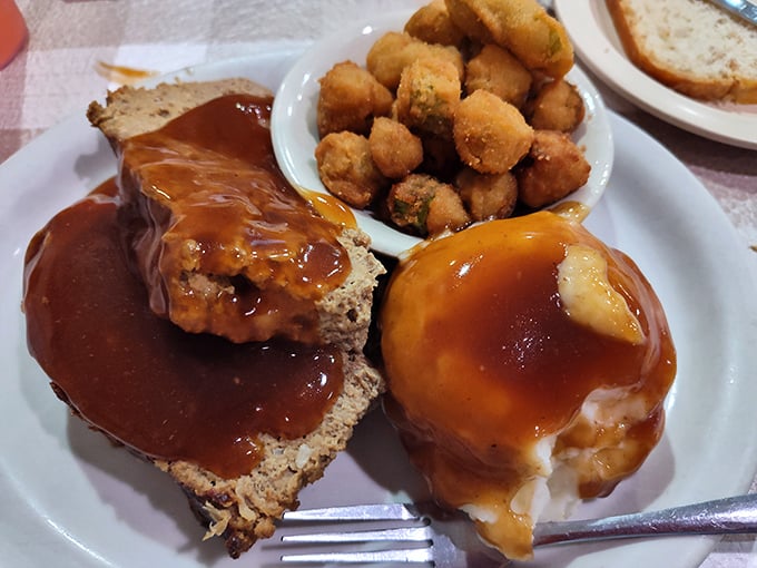 Meatloaf that would make your mother jealous, swimming in gravy that should have its own fan club. This isn't dinner—it's edible nostalgia.