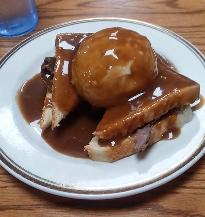Behold the star attraction: meatloaf bathed in rich gravy atop toast. Grandma would be jealous—and maybe a little suspicious.