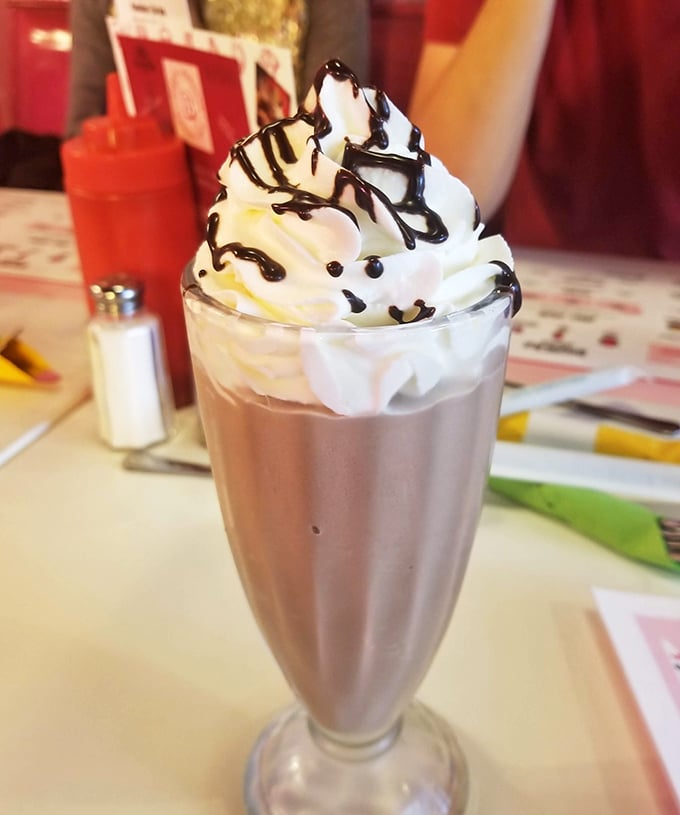 This isn't just a milkshake – it's architecture in a glass, with whipped cream and chocolate drizzle creating a skyline worth demolishing.