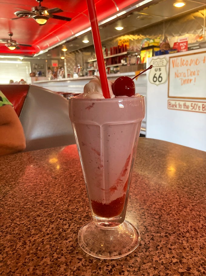 The strawberry milkshake that launched a thousand road trips. Thick enough for a spoon, with that perfect swirl of whipped cream and cherry crown.
