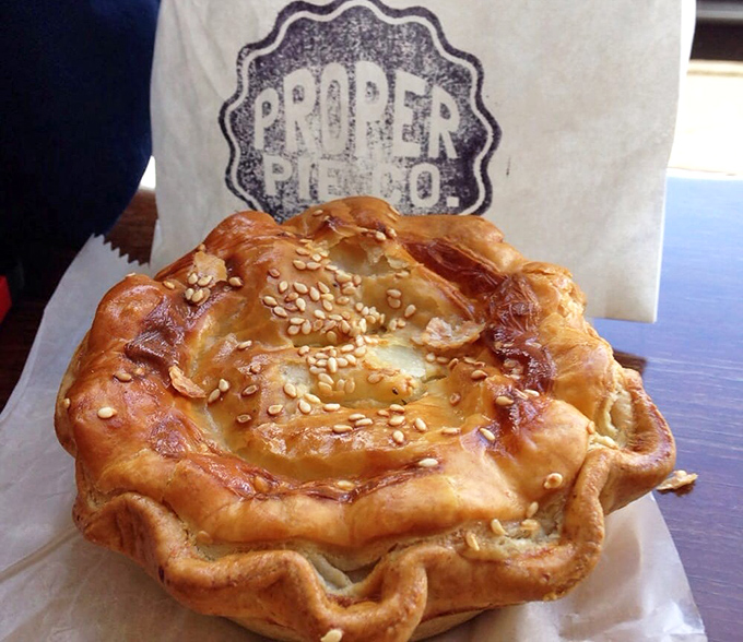 Golden, flaky, and seductively crimped—this savory pie isn't just food, it's edible architecture with a sesame-studded crown fit for royalty.
