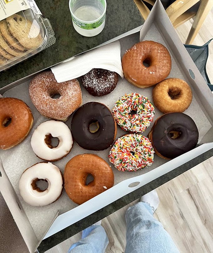 Donut heaven in a box—where sprinkles, chocolate, and glazed classics coexist in perfect harmony, like the world's most delicious peace treaty.
