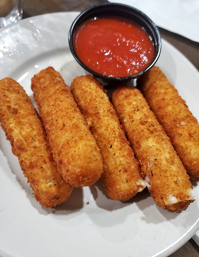 Behold the stars of our show – golden-brown mozzarella sticks with that perfect cheese pull that makes you want to applaud between bites.