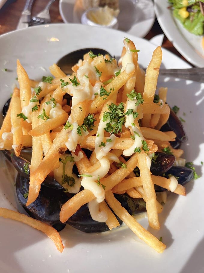 These aren't just fries with mussels—they're a culinary high-wire act where crispy potatoes meet oceanic depth, all tied together with herb-flecked sauce.
