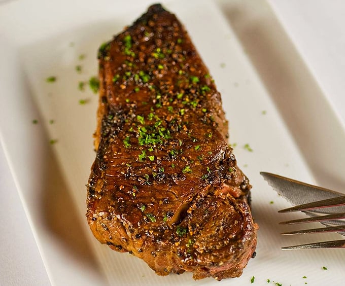 Behold the NY Strip in all its glory—perfectly seared, expertly seasoned, and ready to make you question every other steak you've ever loved.