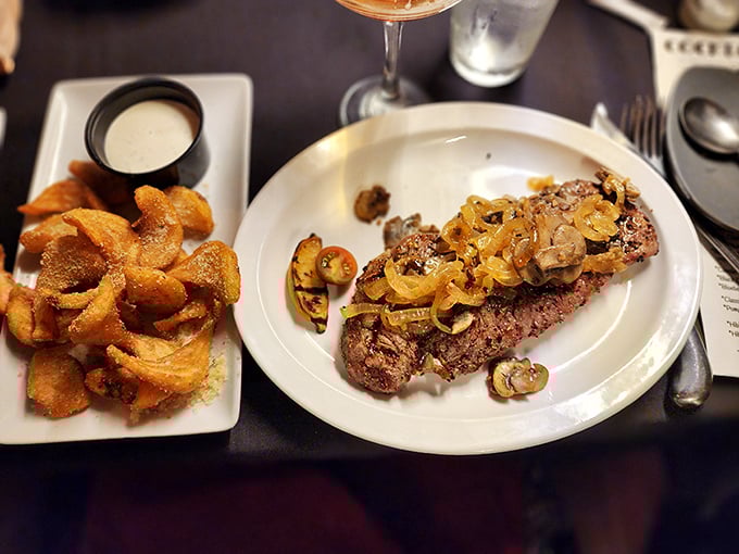 This New York Strip isn't just cooked—it's been coaxed to perfection, with mushrooms and onions that have clearly been sworn to a delicious oath.
