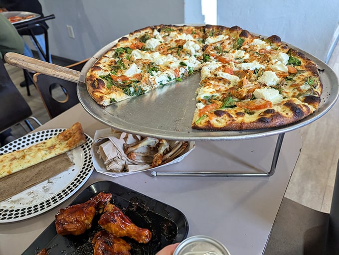 Pizza perfection doesn't need fancy toppings. This wood-fired masterpiece with its blistered crust and fresh basil would make even the most jaded food critic swoon.