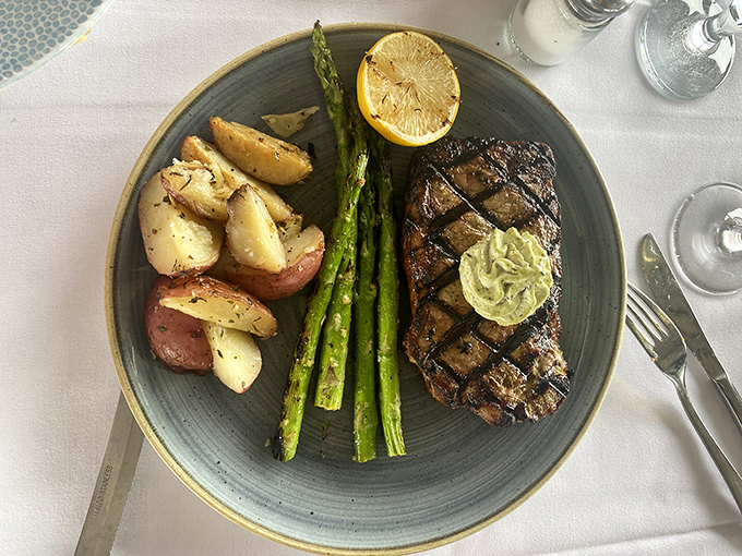 The New York steak arrives like a perfectly grilled love letter to carnivores, with that herb butter slowly melting into a pool of "I'll diet tomorrow" bliss.
