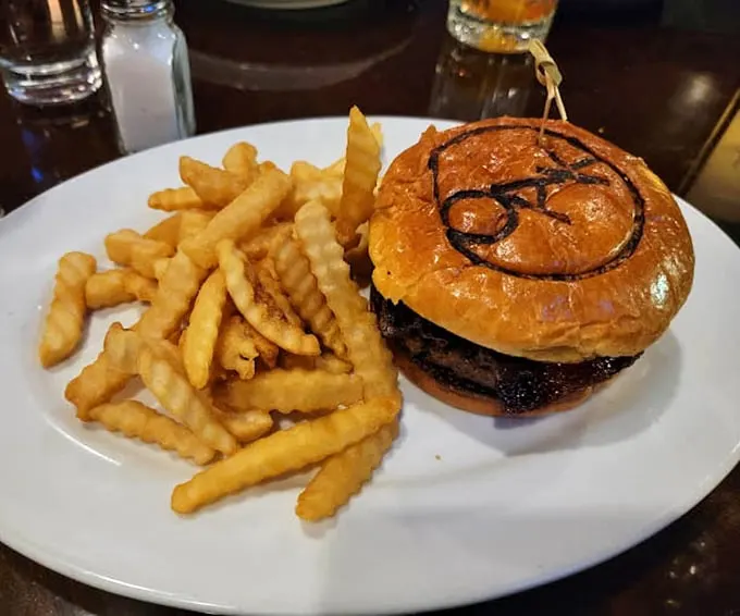 The signature Oak burger arrives like a work of art—branded bun, perfectly charred patty, and golden fries that somehow maintain their crispiness until the very last bite.