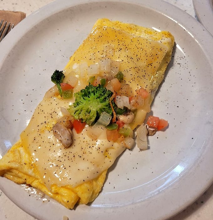 Omelets here aren't just folded eggs—they're edible envelopes delivering good news to your taste buds with every colorful, cheese-draped bite.
