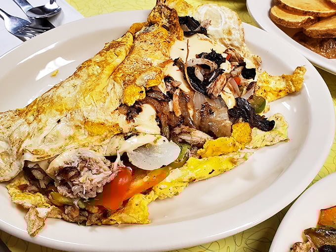 This isn't just an omelet—it's an architectural marvel of eggs, perfectly folded around a treasure trove of fillings. Breakfast engineering at its finest.
