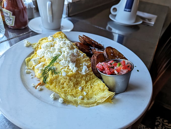 This isn't just an omelet—it's a fluffy yellow canvas painted with feta, garnished with fresh dill, and served with a side of breakfast bliss.