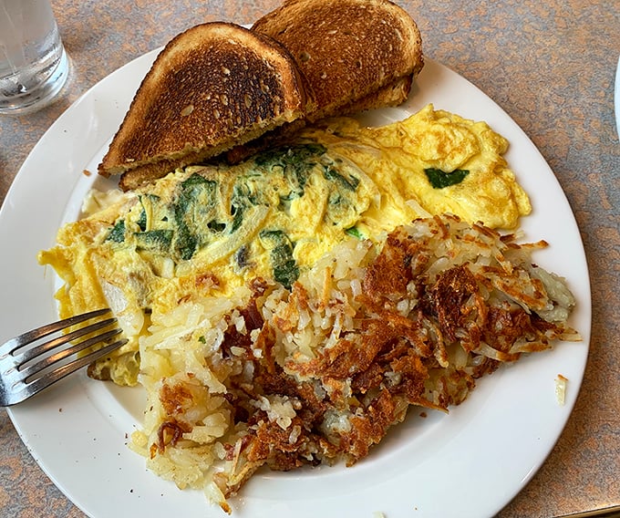 This spinach omelet performs the culinary equivalent of a magic trick – transforming simple ingredients into something that makes you question all other breakfasts.