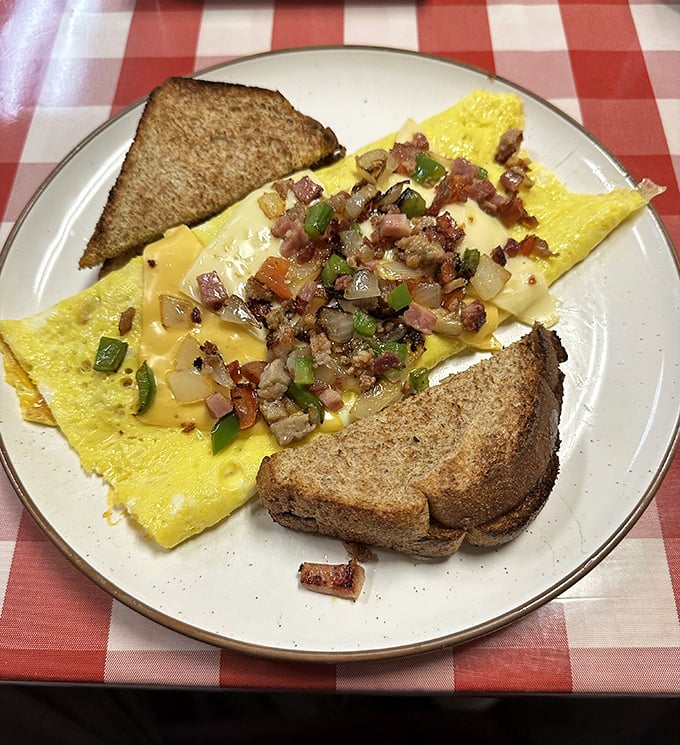 Cheese-draped perfection meets sautéed veggies in an omelet that makes you wonder why breakfast ever has to end.