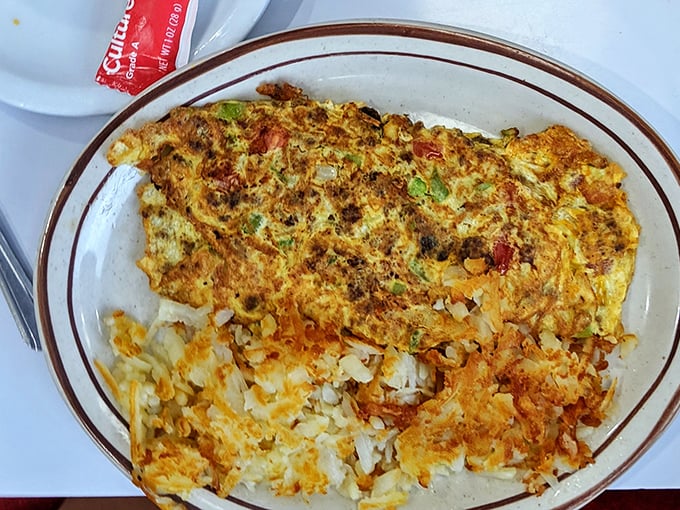 Behold the omelet that launched a thousand return visits—a fluffy masterpiece that makes ordinary eggs seem like they're not even trying.