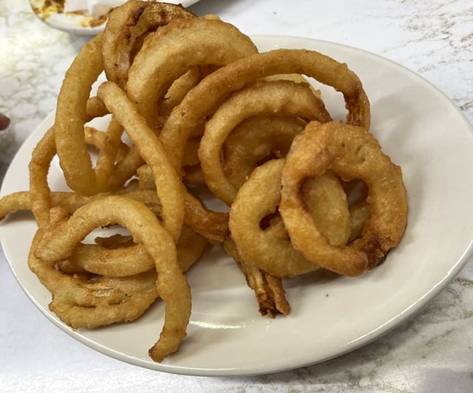 Behold the golden halos of happiness—Duly's onion rings achieve that perfect balance between crispy exterior and sweet, tender onion that makes you forget vegetables are supposed to be healthy.