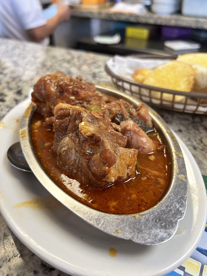 The legendary oxtail stew arrives like a savory lava flow—meat so tender it practically leaps off the bone into your waiting mouth.