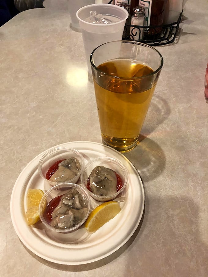 Fresh oyster shooters arrive with a splash of cocktail sauce—a briny, three-bite symphony that's the perfect prelude to seafood bliss.
