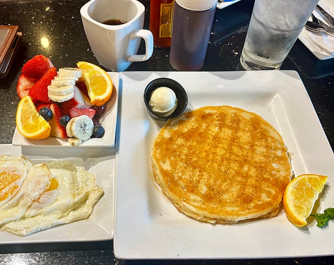 Golden pancake perfection with a side of fresh fruit that looks like it was arranged by a still-life artist. Breakfast as both fuel and art form.