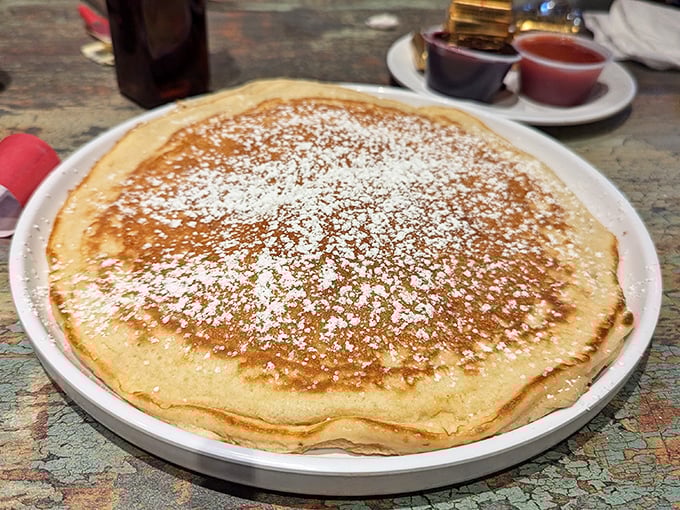 Behold the pancake that launched a thousand road trips—perfectly golden, impossibly fluffy, and dusted with sweet snow.
