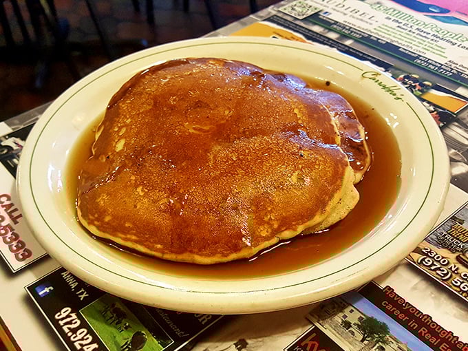 Golden-brown pancakes swimming in syrup—the kind that make you question whether you've ever truly experienced breakfast before this moment.