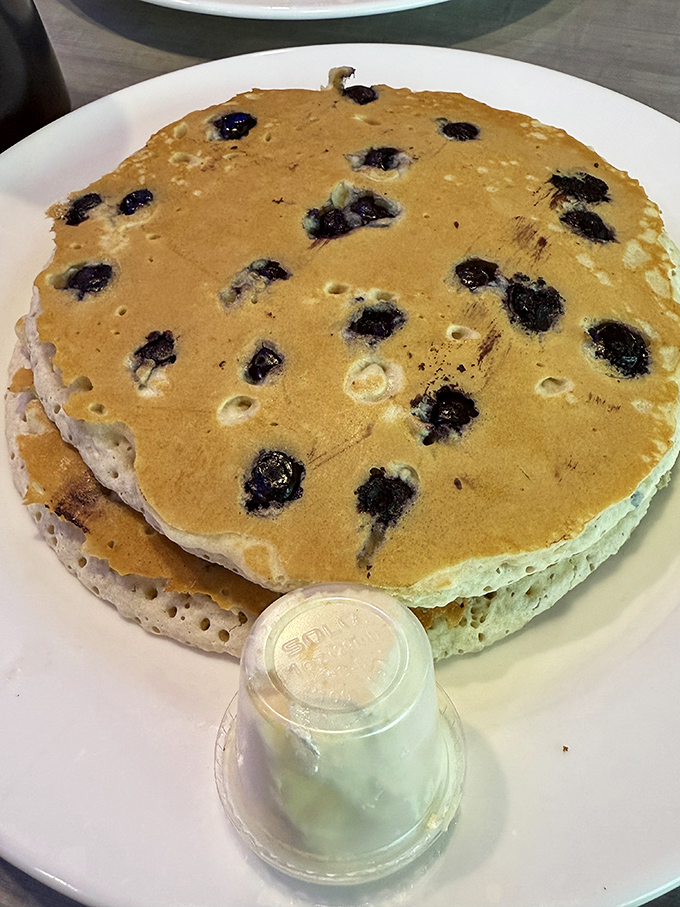 These blueberry pancakes aren't just breakfast—they're edible therapy stacked three high with bursts of berry goodness in every bite.