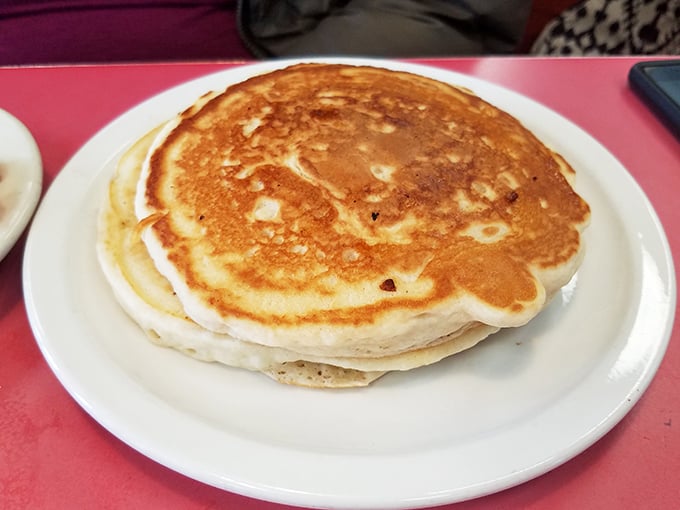 Golden-brown pancakes that look like they graduated from breakfast academy with honors. Fluffy enough to use as a pillow, if you weren't so busy devouring them.