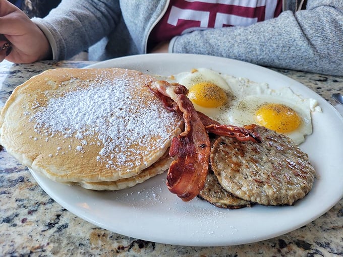 This plate could double as a breakfast buffet – those pancakes are fluffier than a cumulus cloud.
