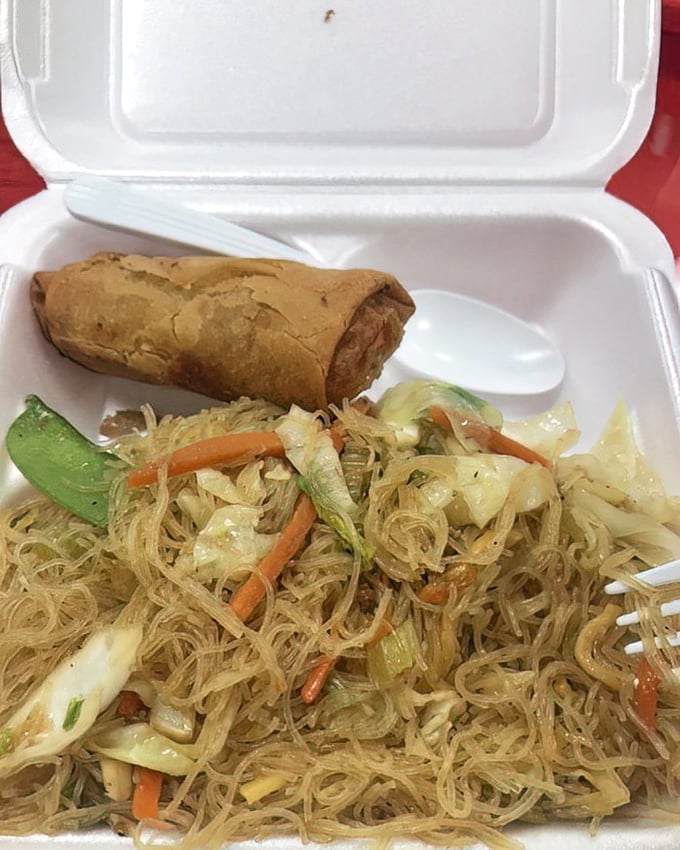This is pancit in its natural habitat – delicate rice noodles mingling with fresh vegetables and a lumpia sidekick that's ready for its close-up.