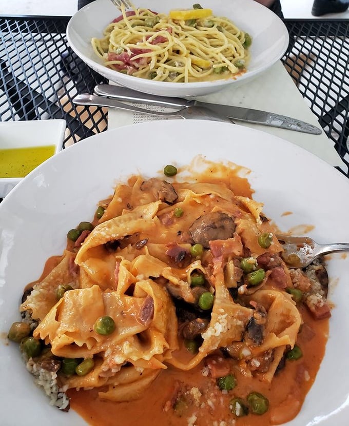 This isn't just pasta—it's a religious experience. Wide ribbons of pappardelle embrace a hearty ragù studded with peas, creating the perfect marriage of texture and flavor.