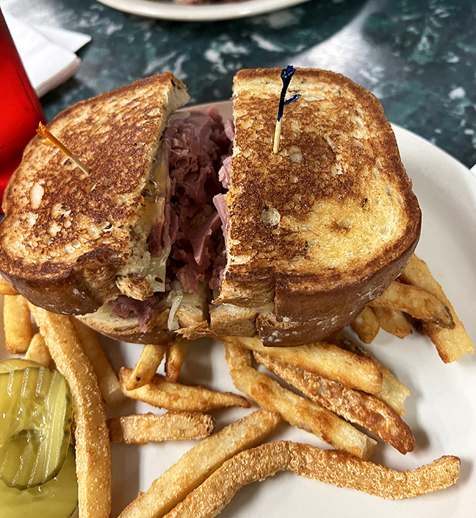 This golden-grilled sandwich isn't just lunch – it's an architectural marvel of melty cheese and savory meat that demands to be photographed before devoured.