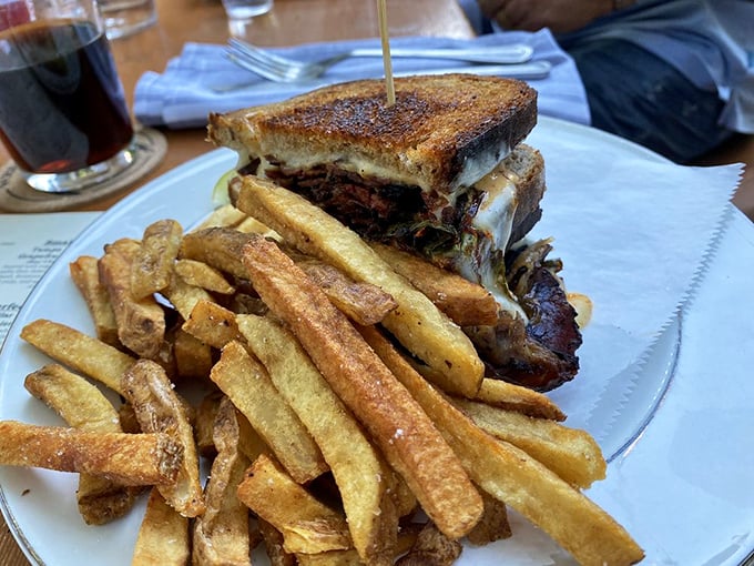 This isn't just a sandwich—it's architecture. Layers of house-cured pastrami and melted cheese create the Brooklyn apartment I could never afford.