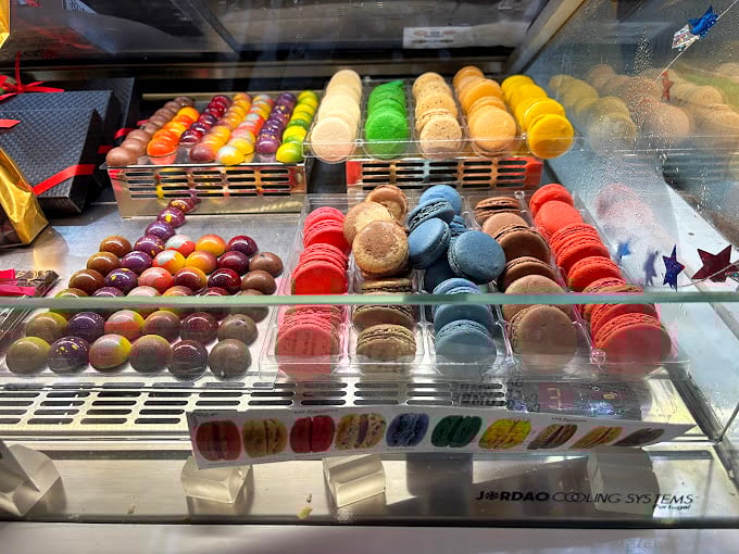 The macaron rainbow isn't just a feast for the eyes—it's edible architecture, where each perfectly formed shell represents countless hours of French pastry tradition.