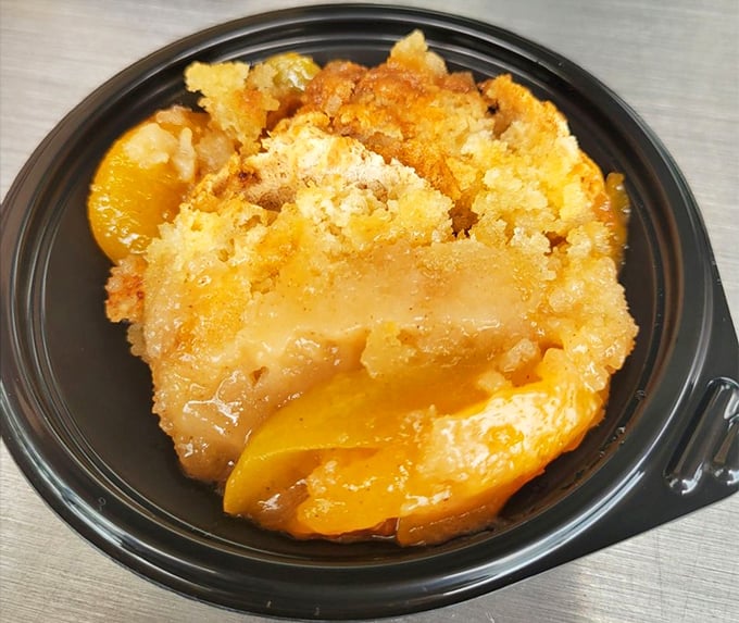 The legendary peach cobbler that launched a thousand road trips—golden, bubbling, and worth every mile of the journey to get here.