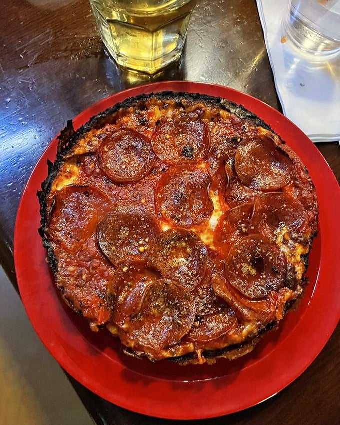 That blackened caramelized crust isn't a mistake – it's pizza nirvana. The pepperoni cups holding tiny pools of flavor are just showing off at this point.